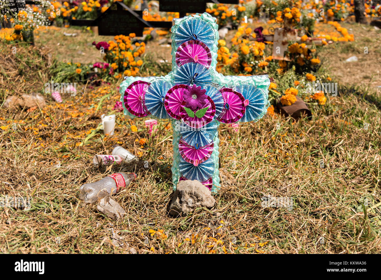 Litter next to the decorated grave marker during the Day of the Dead ...
