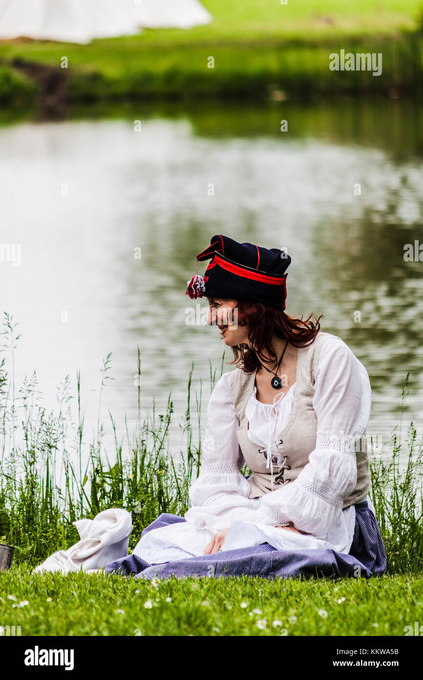 Woman of the napoleonic period sitting on the grass Stock Photo - Alamy