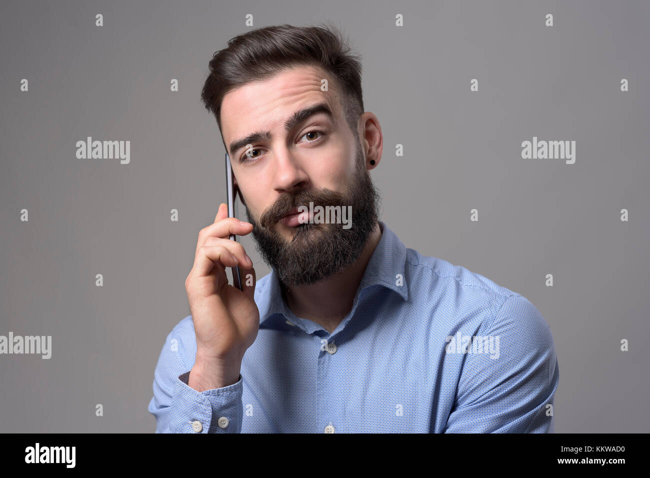 Funny raised eyebrow puzzled facial expression of young business man ...