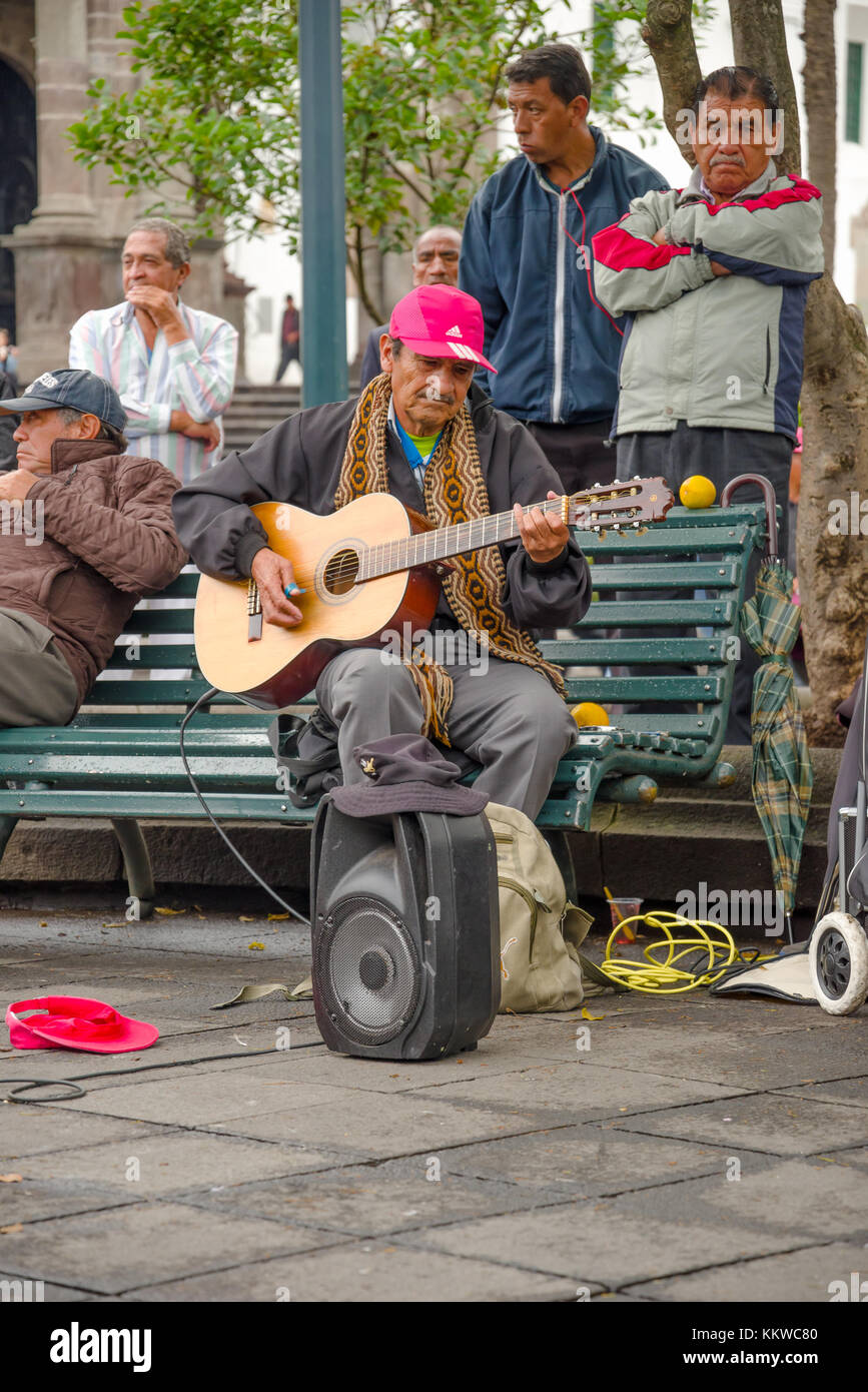 QUITO, ECUADOR NOVEMBER, 28, 2017: Outdoor view of some old musician people sitting in a public ...