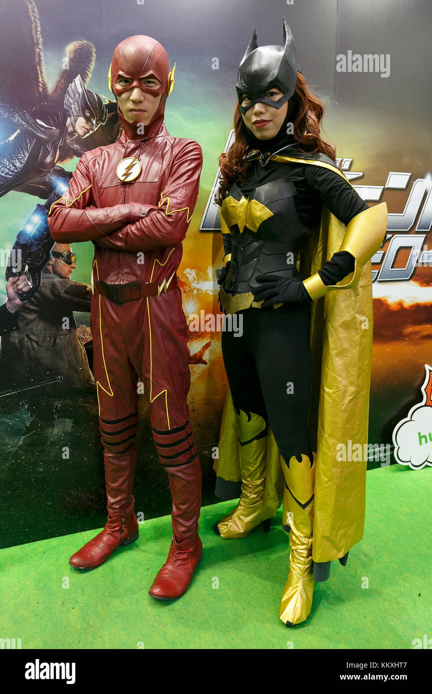 Cosplayers dressed as Flash and Batgirl, pose for a photograph during ...