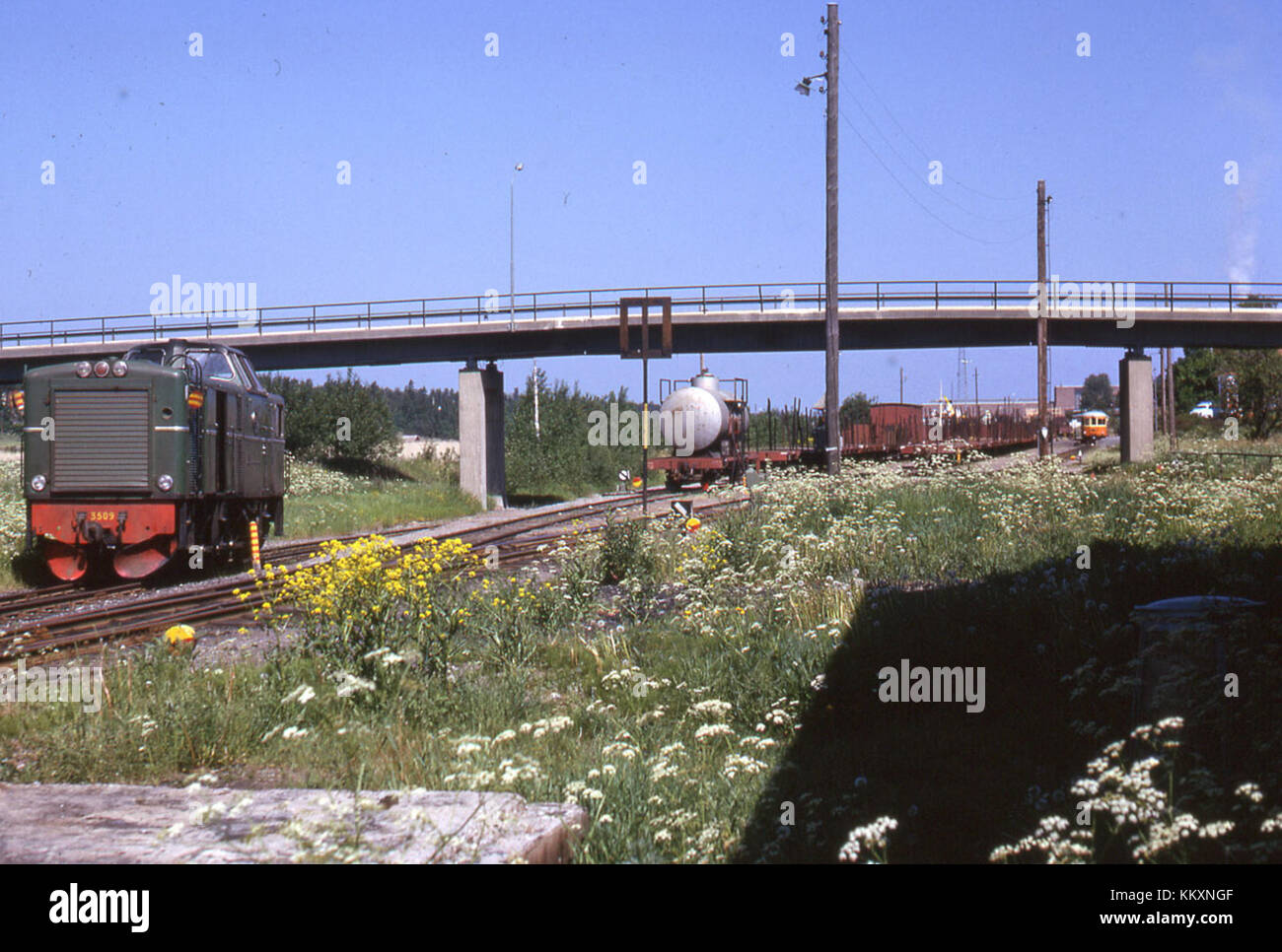 This image depicts a diesel locomotive and freight cars in Hallstavik ...