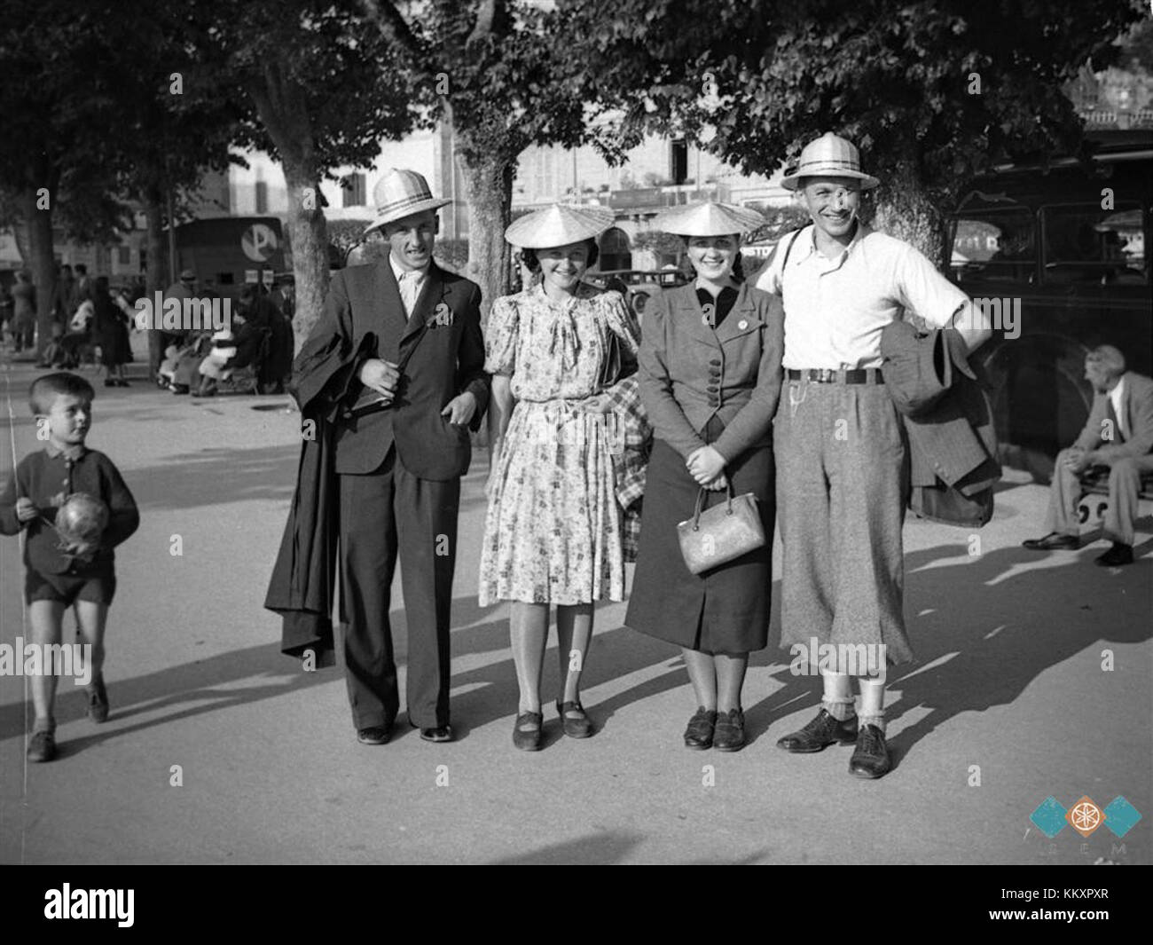 This photograph from 1934 shows a group of people under the Roman sun ...