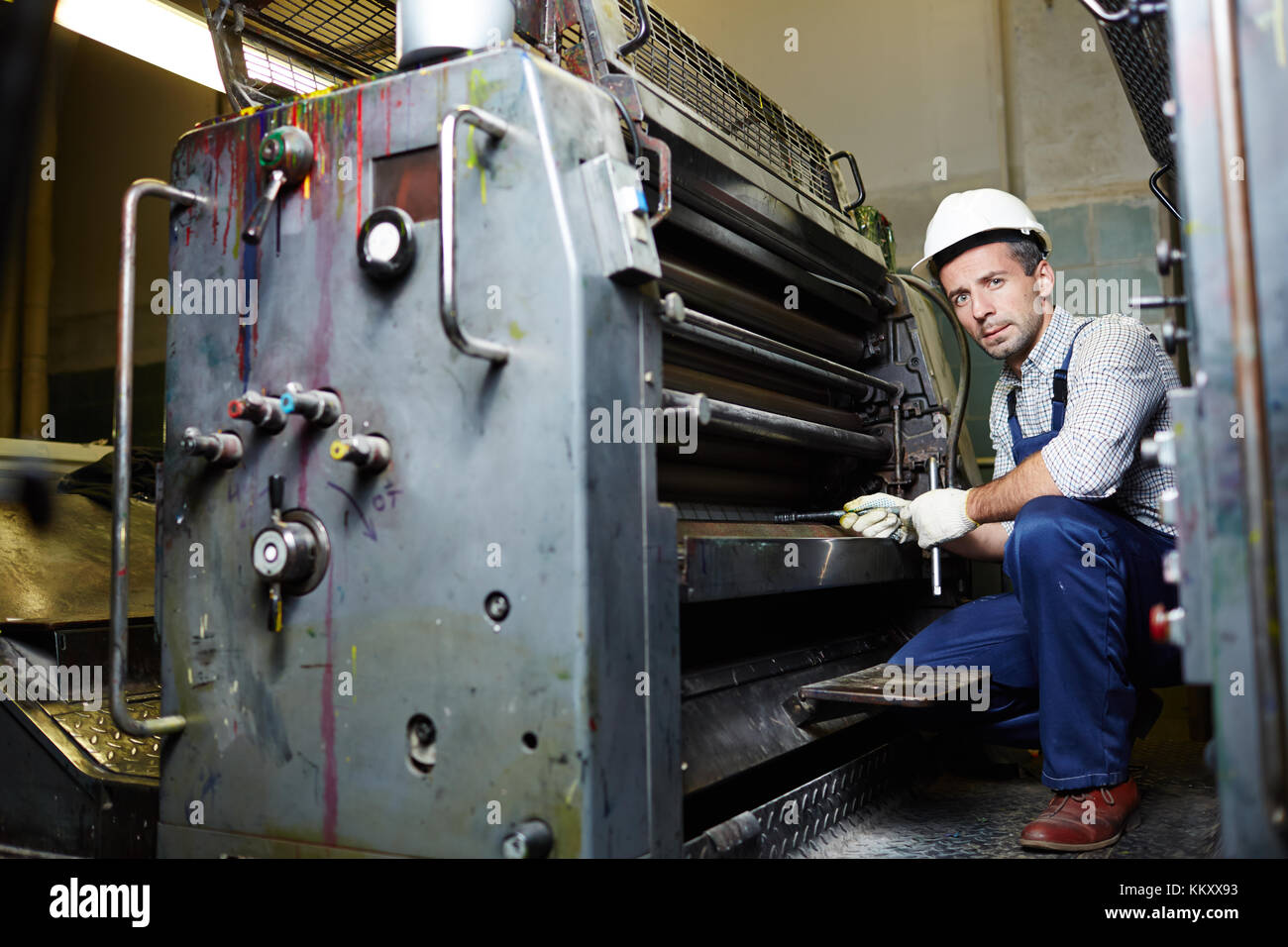 Repair engineer in uniform checking operability and regulating system ...