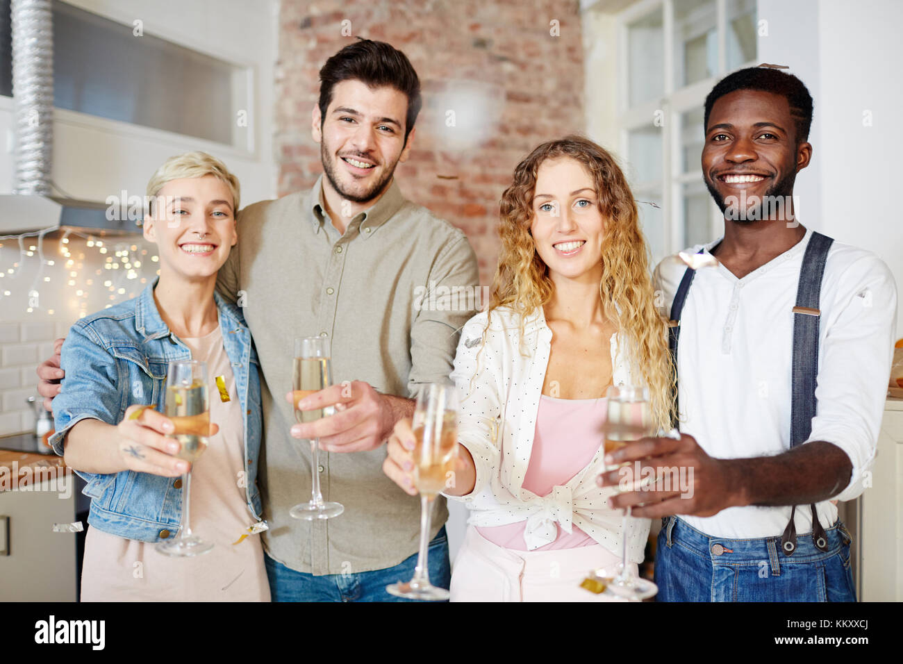 Two happy couples toasting with champagne and wishing you merry xmas ...