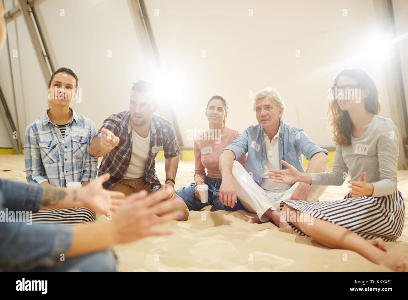 Confident guy pointing at speaker during debate at motivation session ...