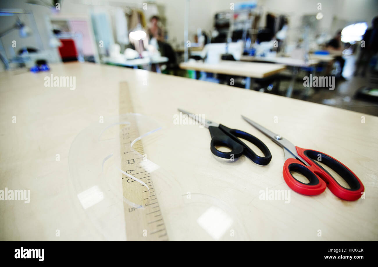 Two scissors and ruler on workplace of modern tailor in workshop Stock ...
