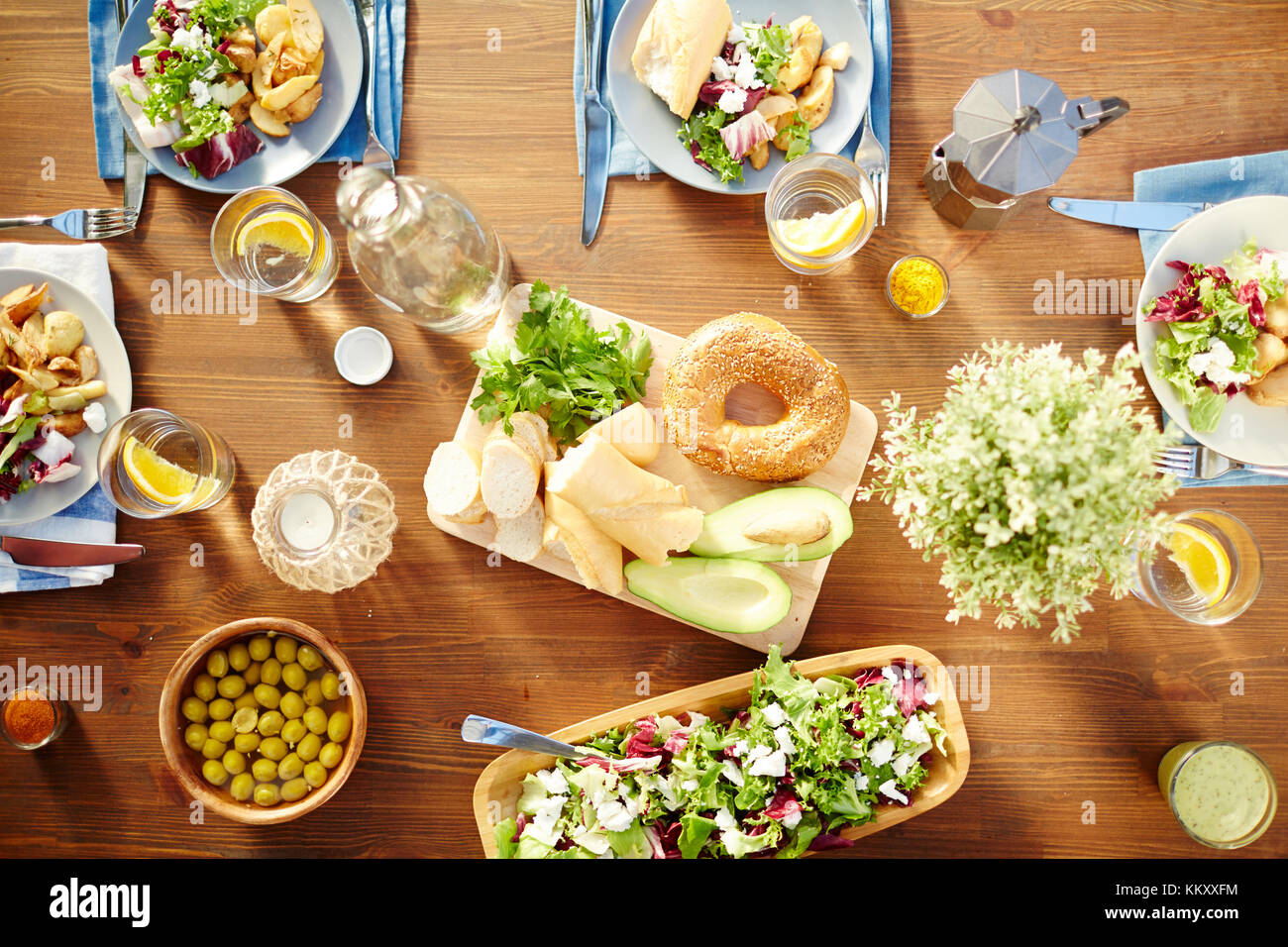 Overview of wooden table served with fresh homemade salad, bread, fruit ...