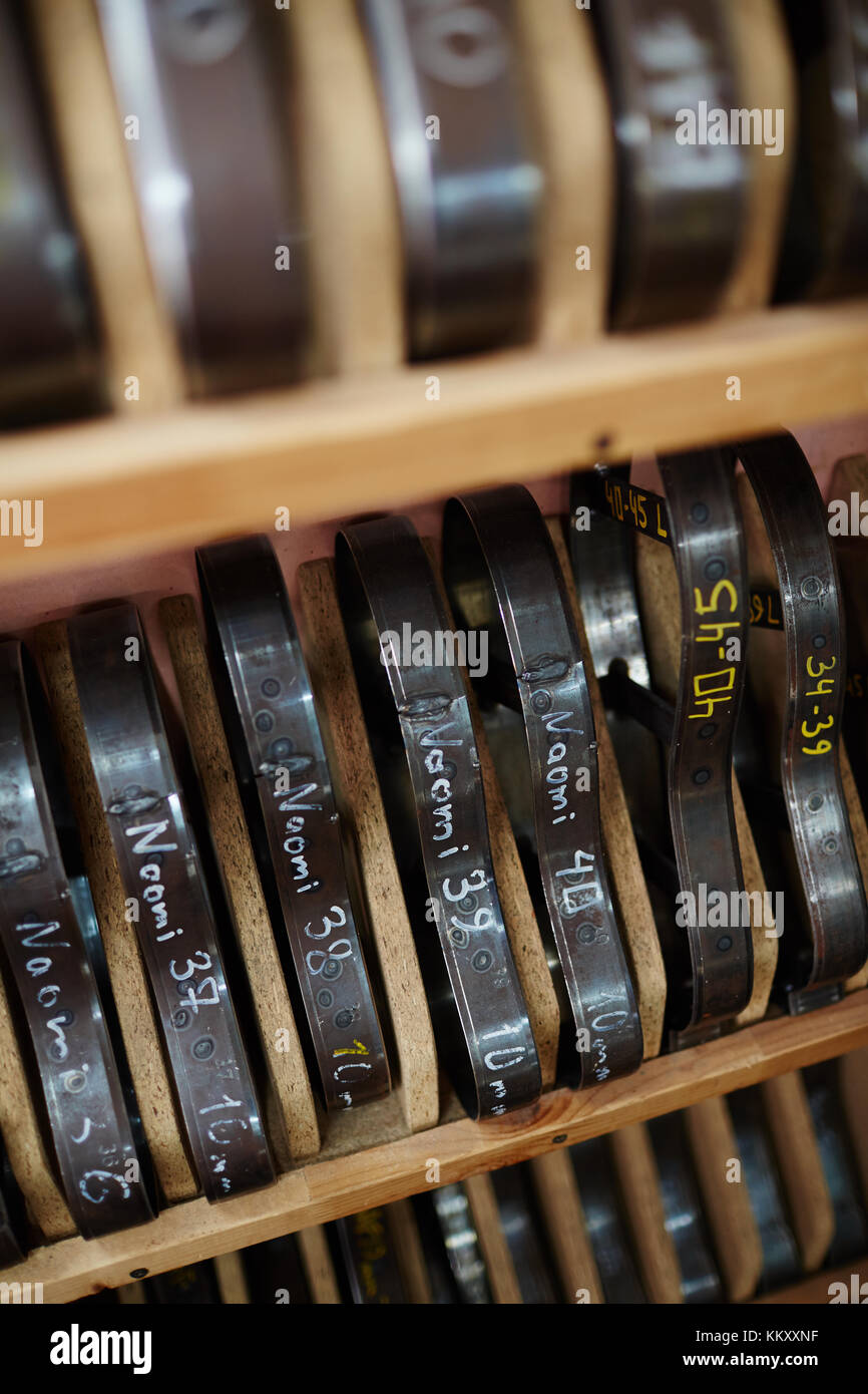 Shelves with metallic sole workpieces for shoes in workshop of ...
