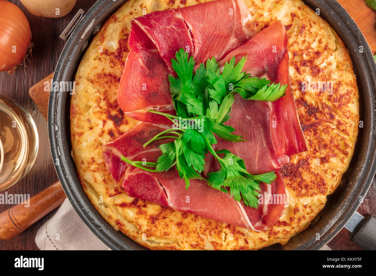 An overhead closeup photo of a Spanish tortilla in a traditional ...