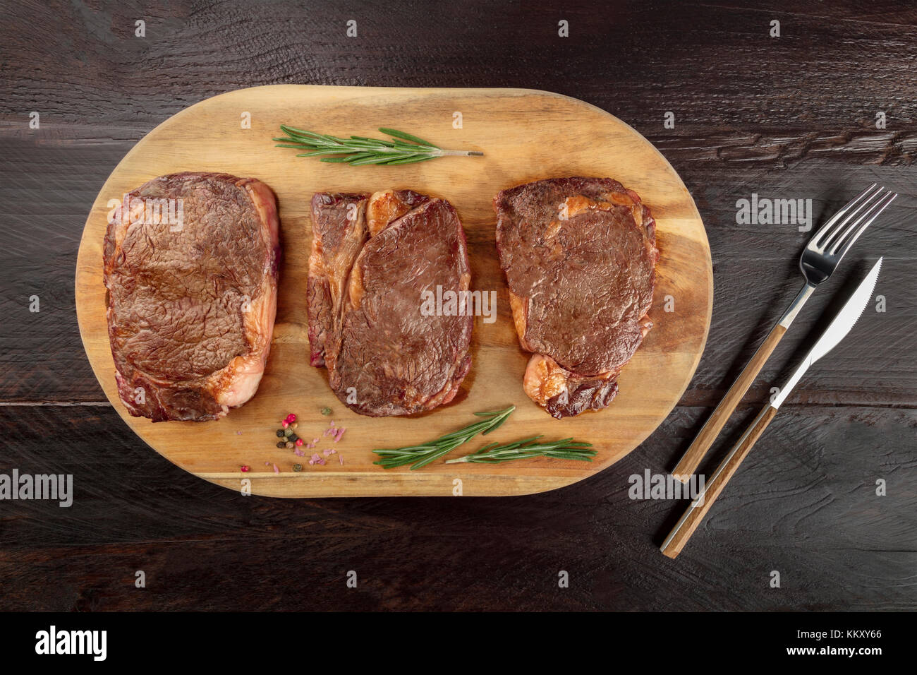 An overhead photo of three slices of cooked meat, beef fillets, shot ...