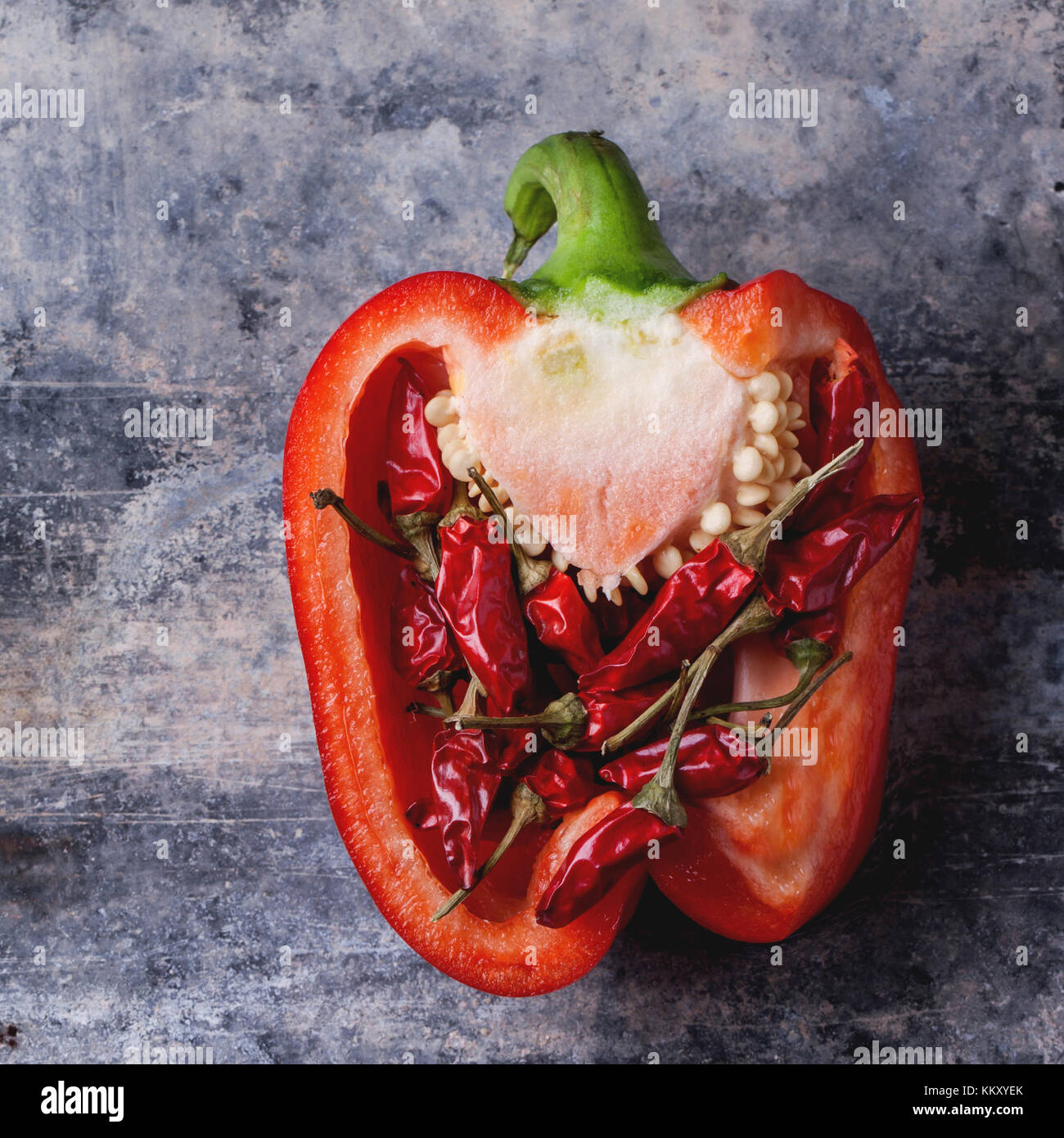 Half of raw red paprika stuffed by little red hot chili peppers over ...