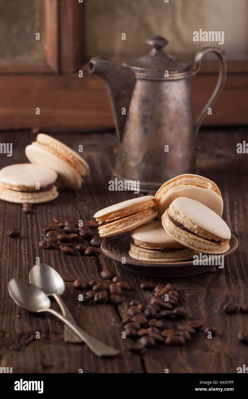 Homemade macaroons on ceramic plate with silver spoon, old silver ...