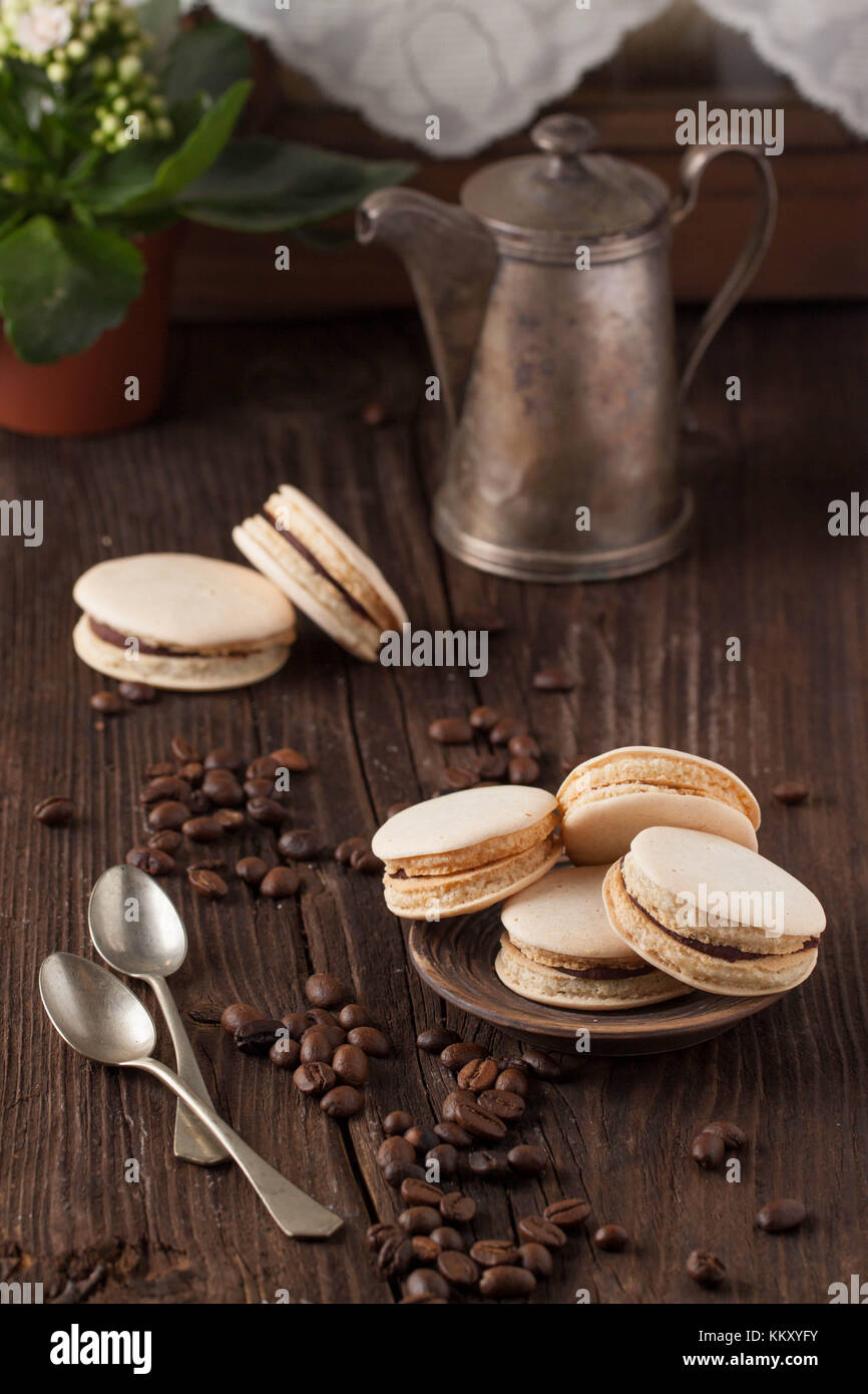 Homemade macaroons on ceramic plate with silver spoon, old silver ...