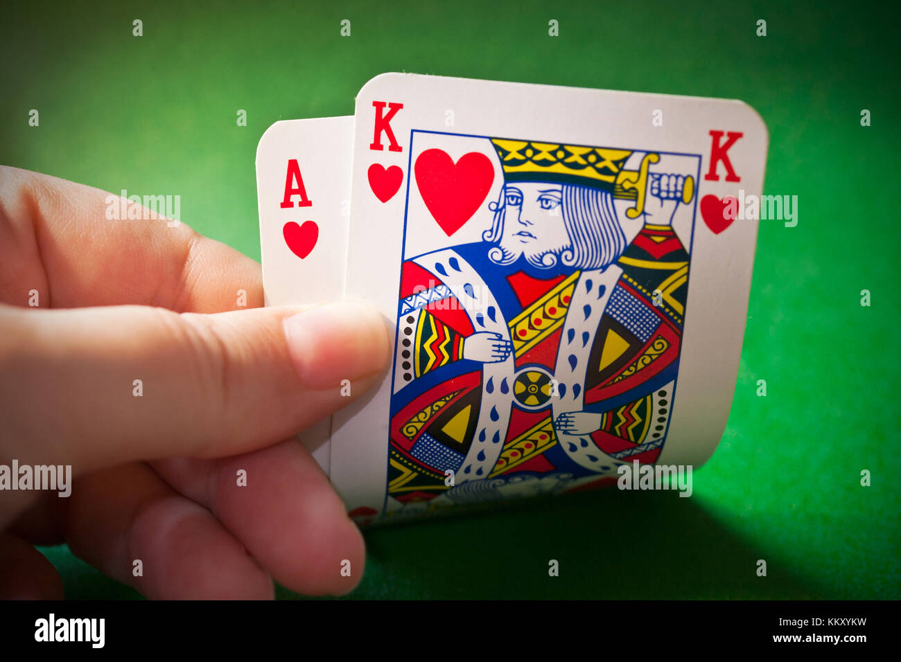 playing cards / player hand with cards - A and K card on green ...