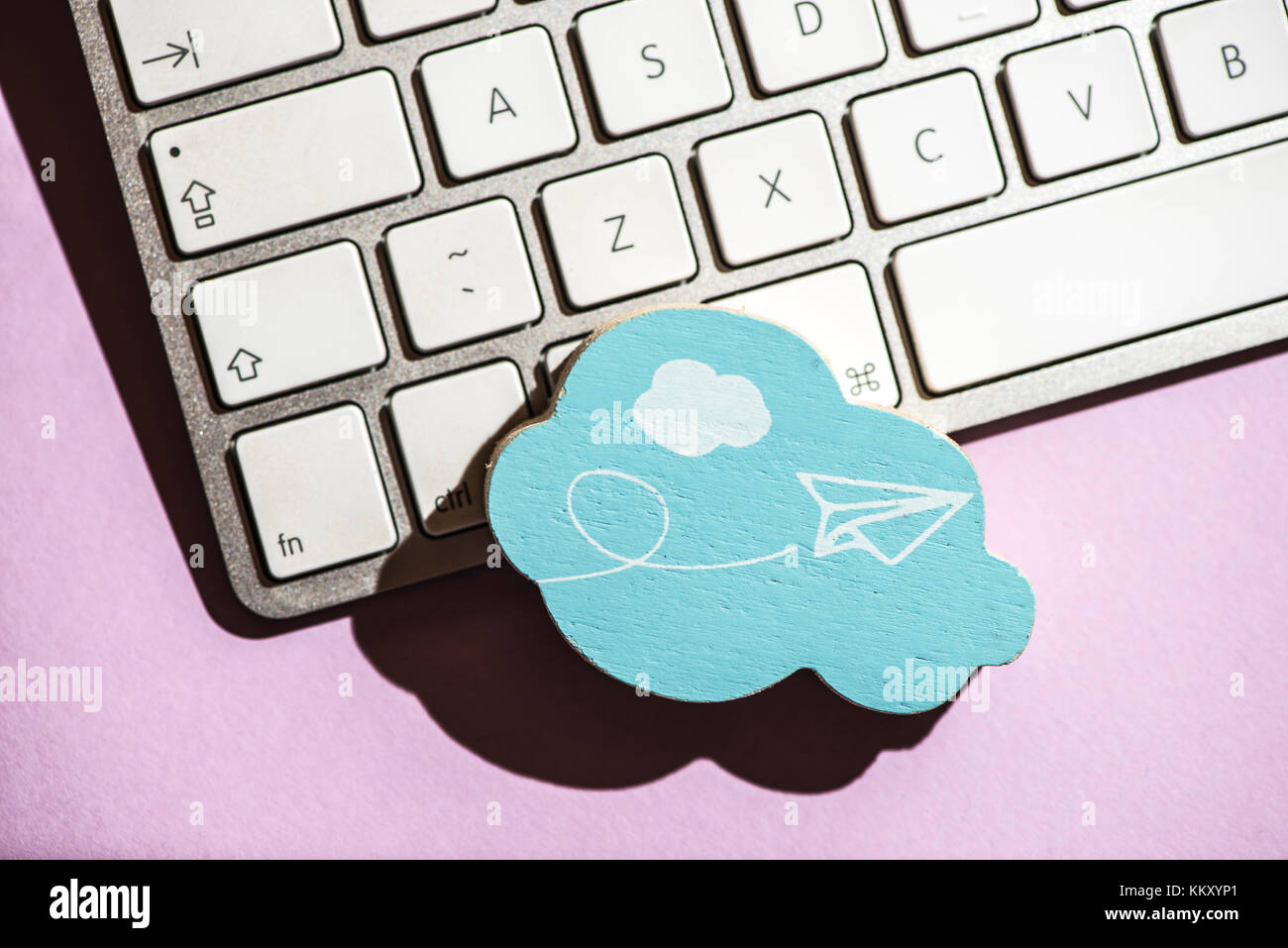 Cloud figure and keyboard on violet Stock Photo - Alamy