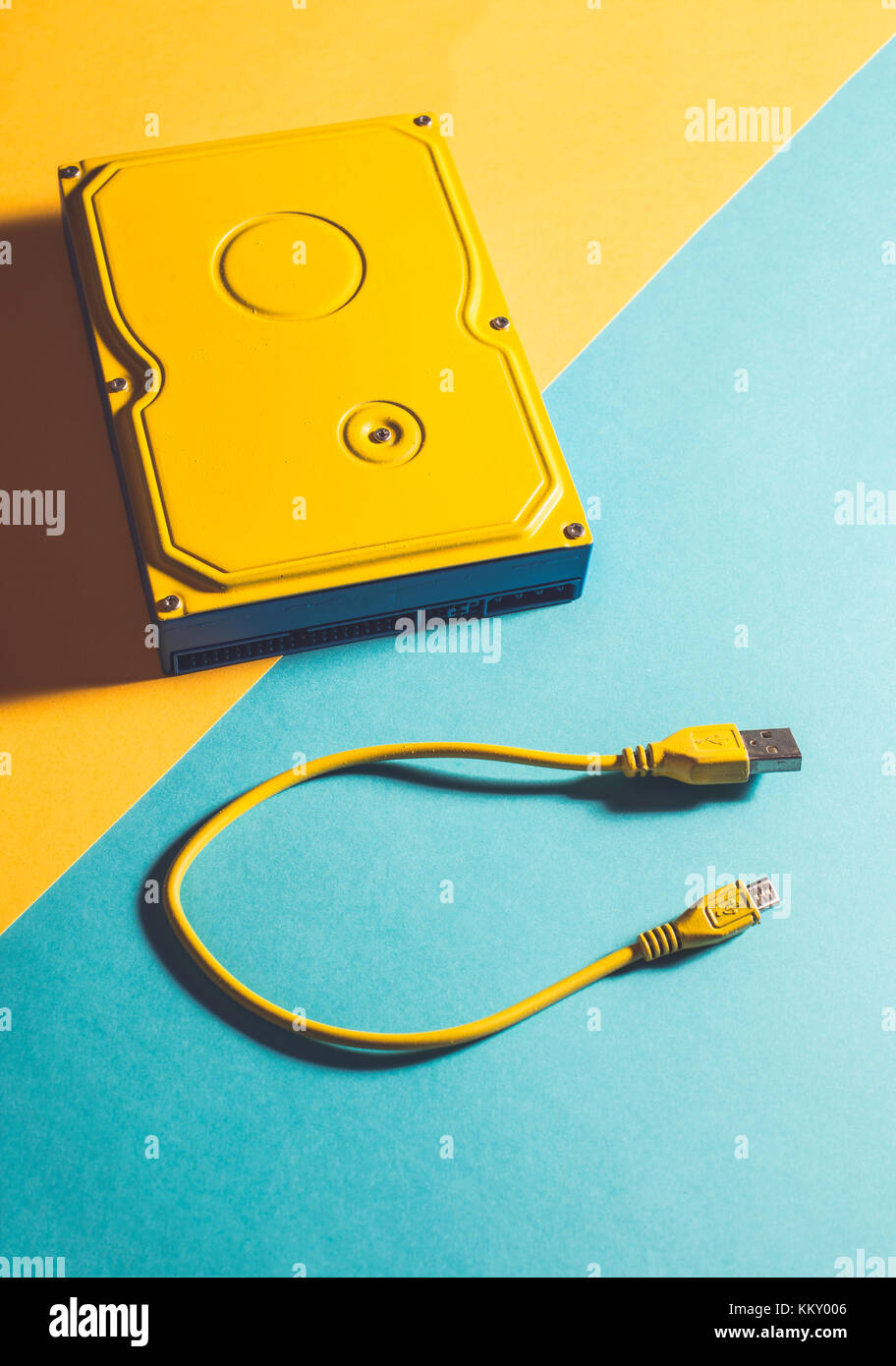 Blue colour hard disc and yellow USB cable Stock Photo - Alamy