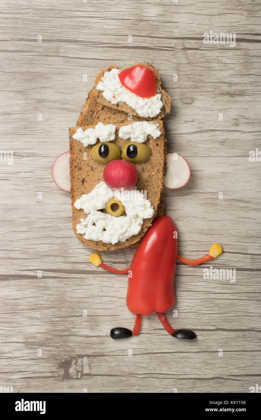 Dancing Santa made as sandwich on wooden background Stock Photo - Alamy