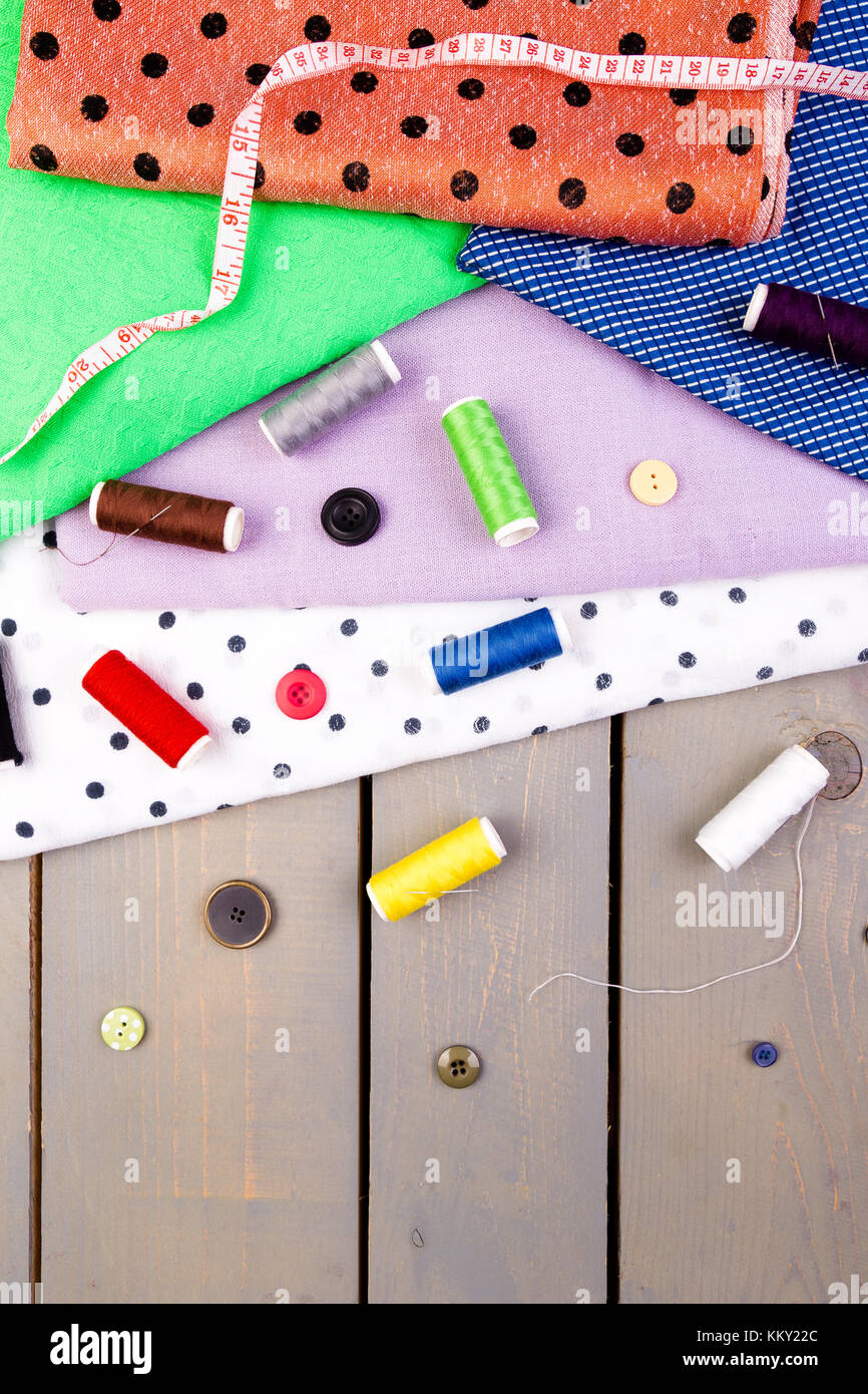 Items for sewing clothes. Sewing buttons, spools of thread and cloth ...
