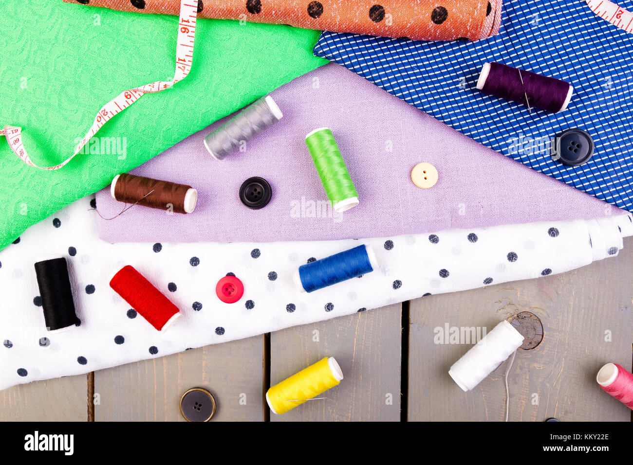 Items for sewing clothes. Sewing buttons, spools of thread and cloth ...