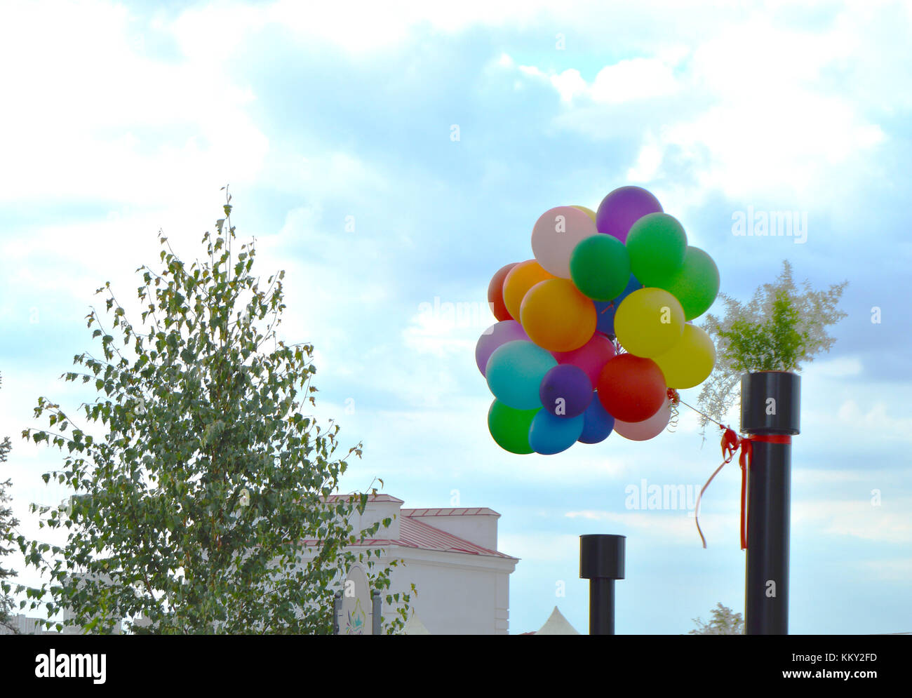 Colorful balloons on sky background in summer city Park Stock Photo - Alamy