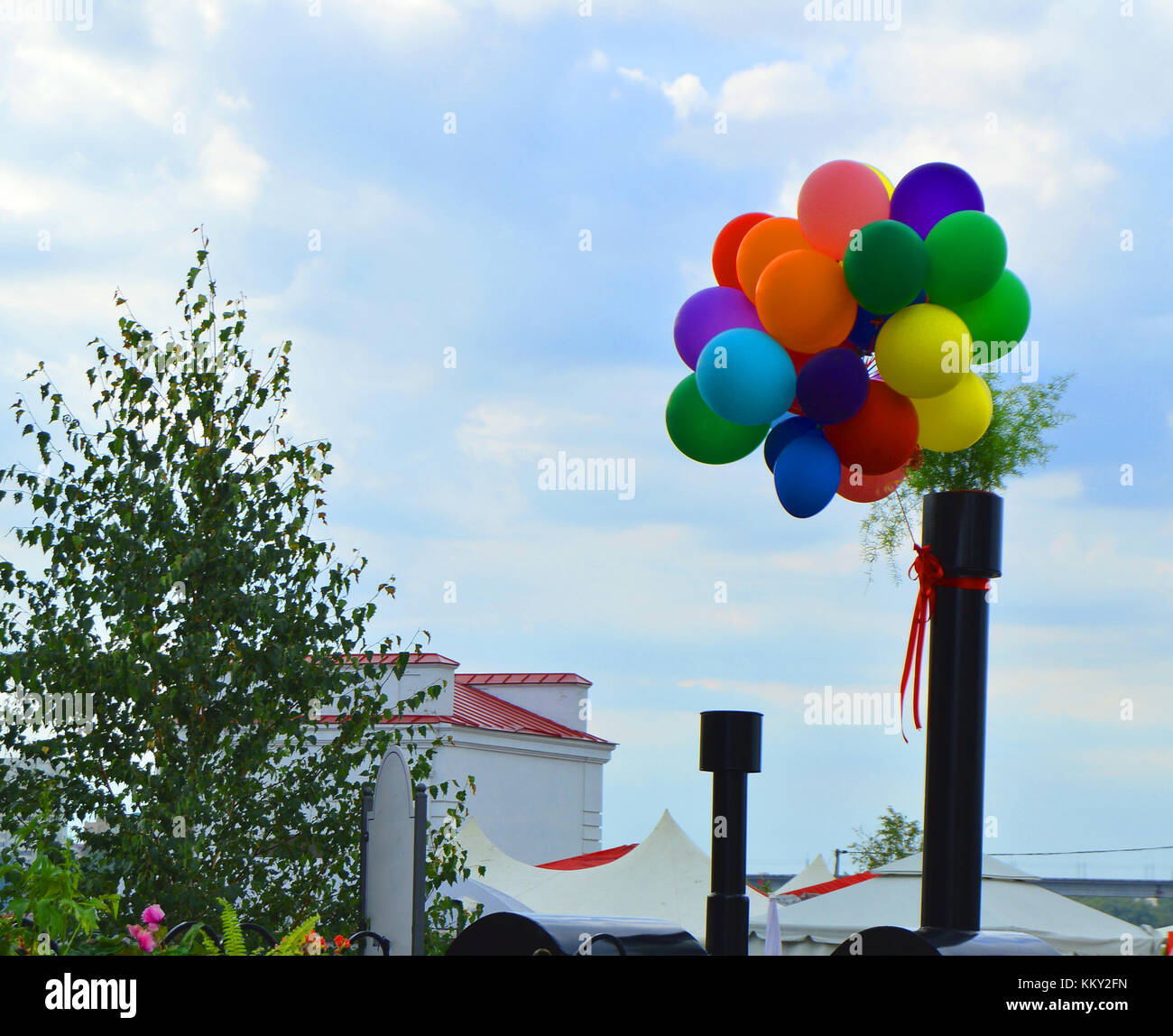 Colorful balloons on sky background in summer city Park Stock Photo - Alamy