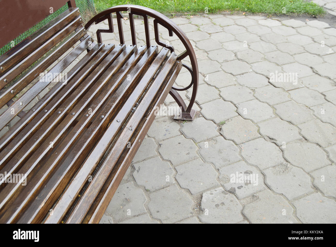 Brown wooden bench on the street in summer Park Stock Photo - Alamy
