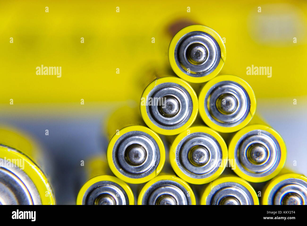 Stack of yellow AA batteries close up abstract color background Stock ...