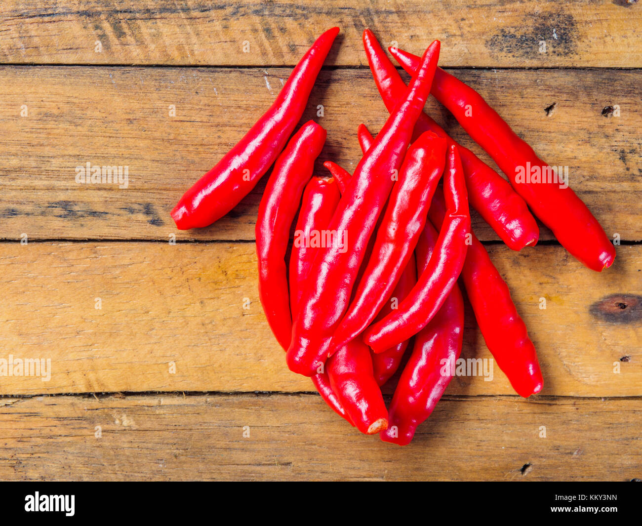 chilli on wood background Stock Photo - Alamy