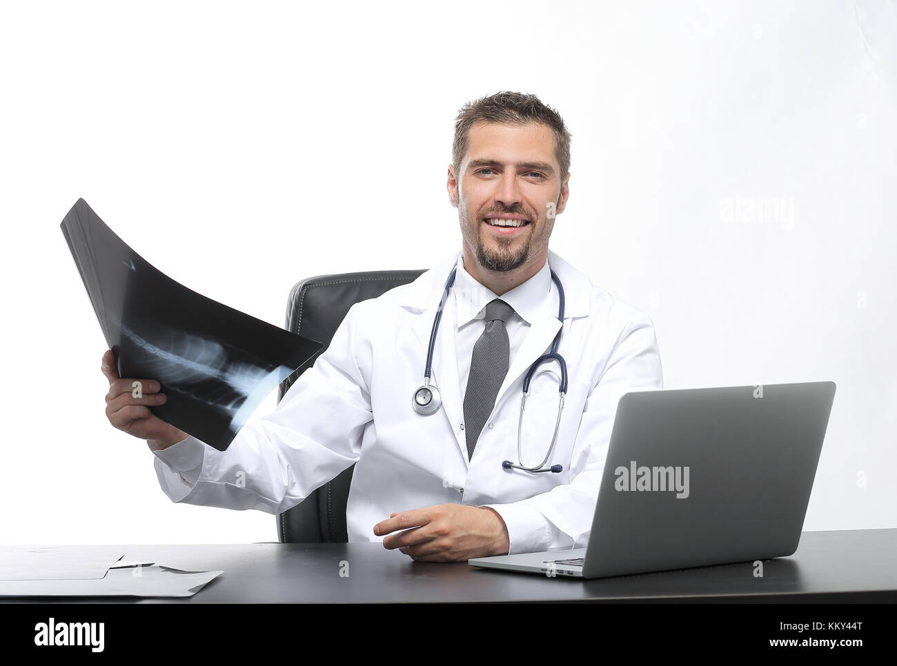 doctor examines an x-ray,sitting behind a Desk Stock Photo - Alamy