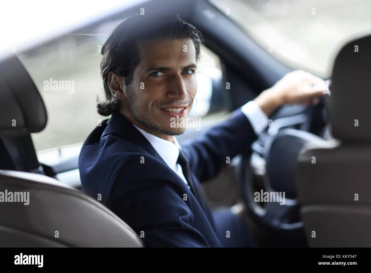 man sitting behind the wheel of a car Stock Photo - Alamy