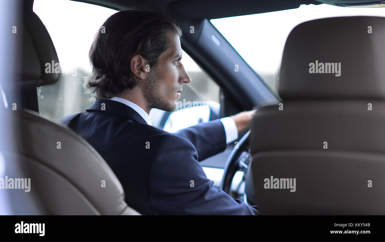 successful man sitting behind the wheel of a car Stock Photo - Alamy