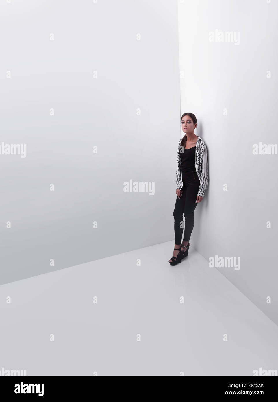 young woman leaning on wall Stock Photo - Alamy