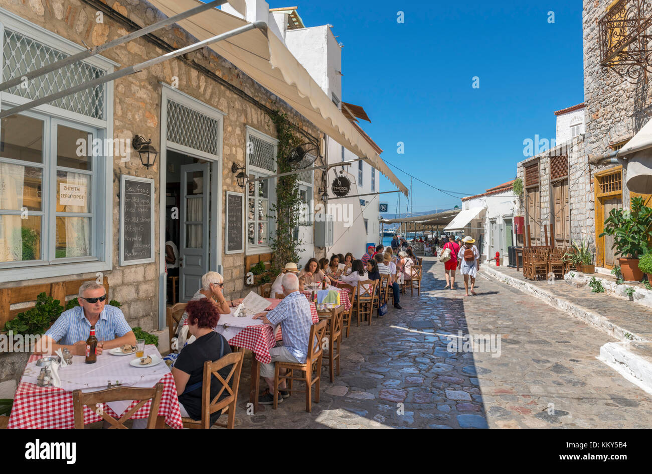 Traditional Greek taverna on a typical street near the harbour, Hydra ...
