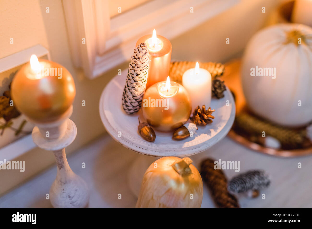 Console table, detail, autumnal decoration, candles, cones Stock Photo ...