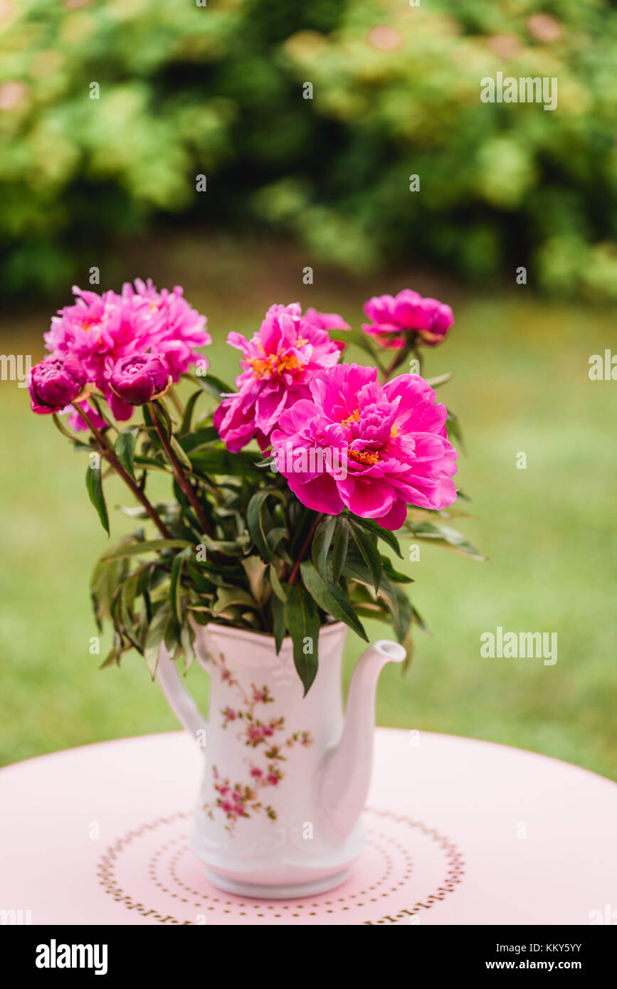 Garden table, pot, peonies Stock Photo - Alamy