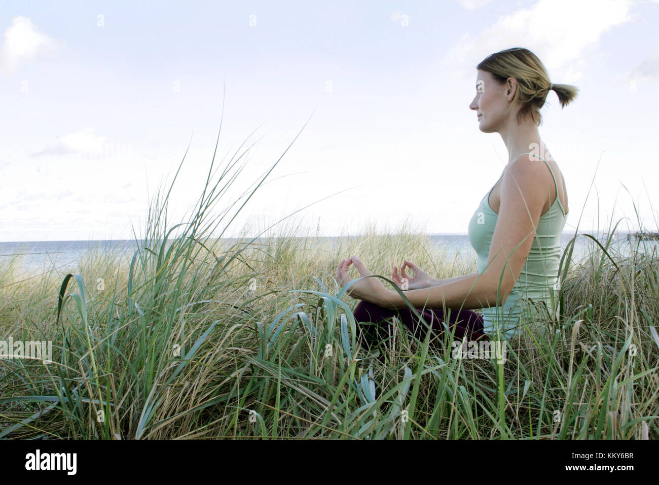Woman, dunes, meditation, side view Stock Photo - Alamy