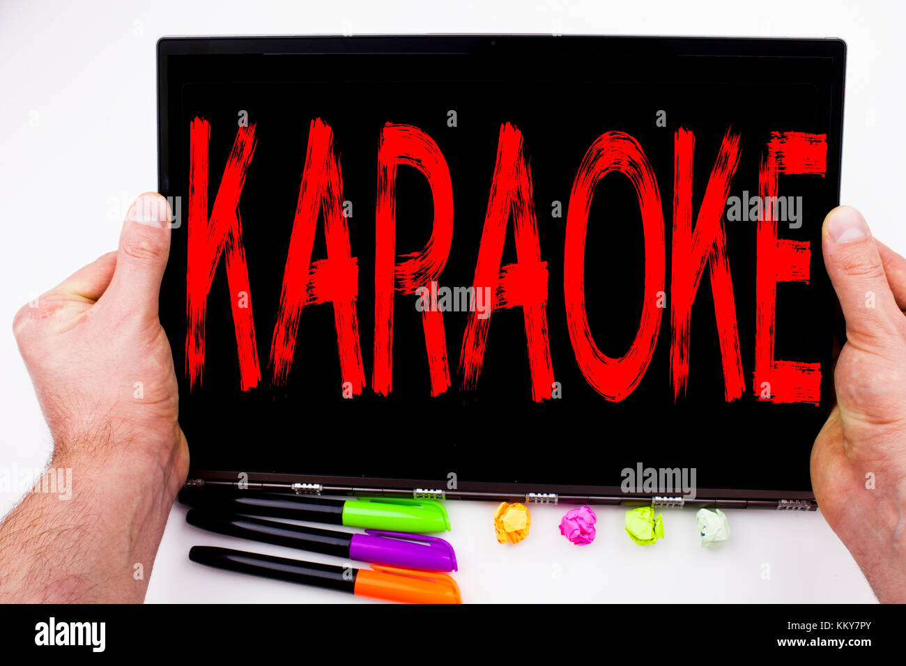 Karaoke text written on tablet, computer in the office with marker, pen ...