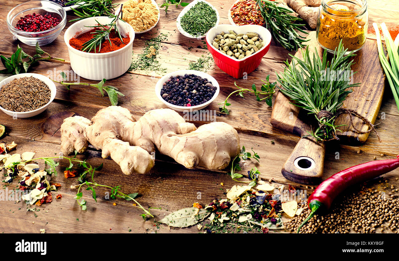Colorful spices and fresh herbs on rustic wooden background Stock Photo ...