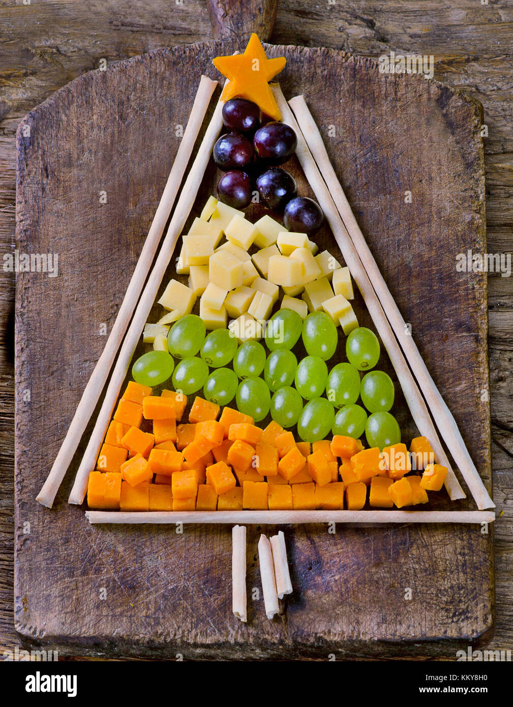 Christmas cheese and grape tree on a wooden board. Top view Stock Photo ...