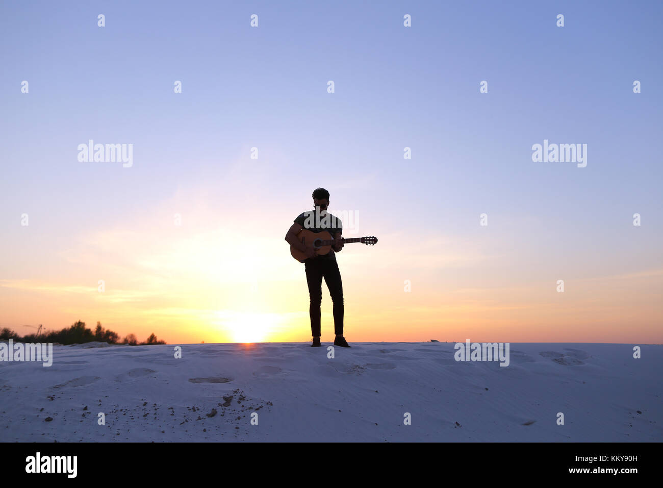Handsome Arab young guy learns to play rock music on musical string ...