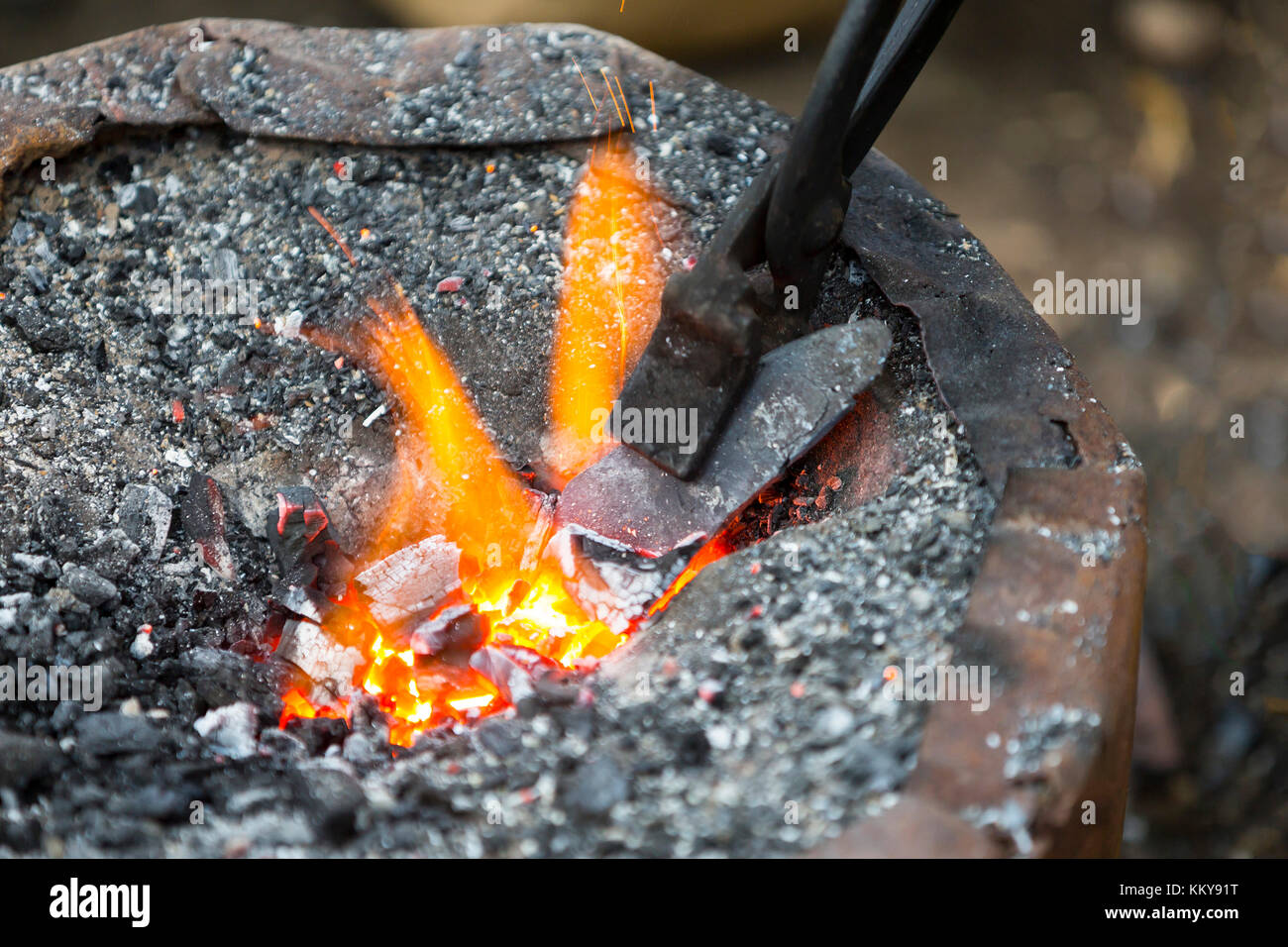 Hot metal arrow blade in the fire before being hammered by a blacksmith ...