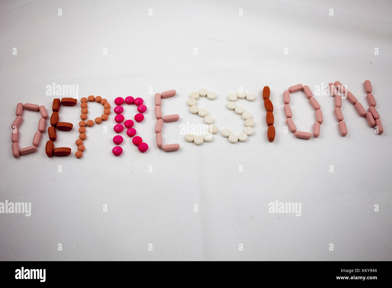 A depression word, writing on the white background on pills with copy ...