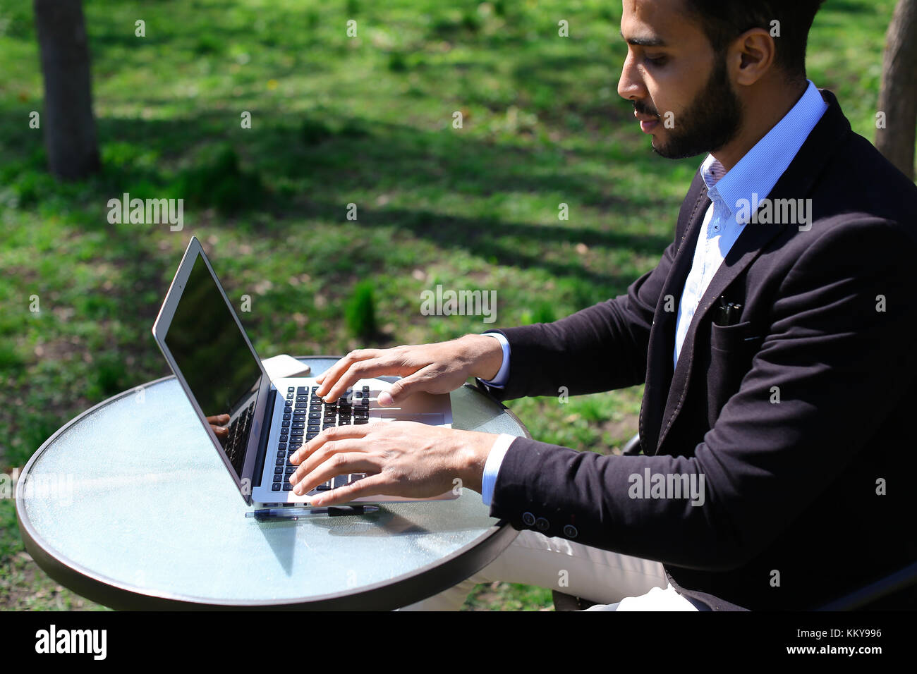 Handsome person using laptop and clicking keyboard, putting hands up ...