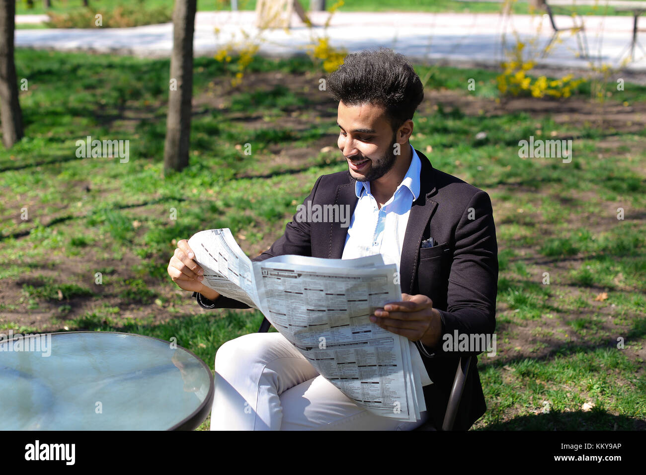 Close-up photography, man reading newspaper and smiling with dimples on ...
