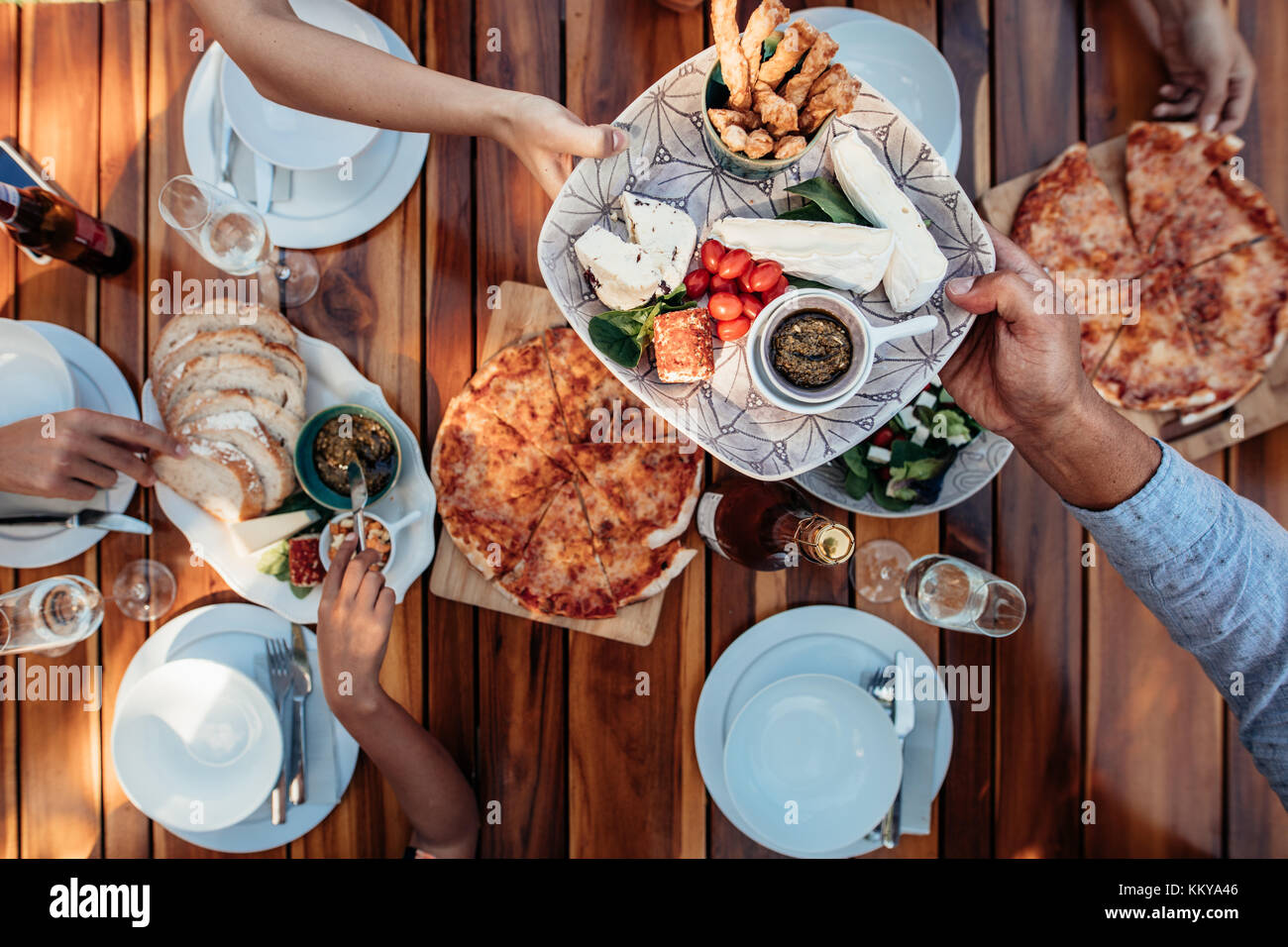 Top view of people eating meal at table served for party. Friends ...