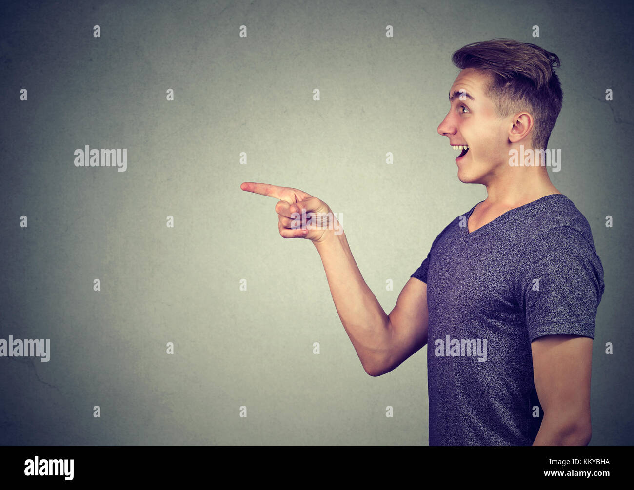 Side profile of a surprised man pointing finger Stock Photo - Alamy