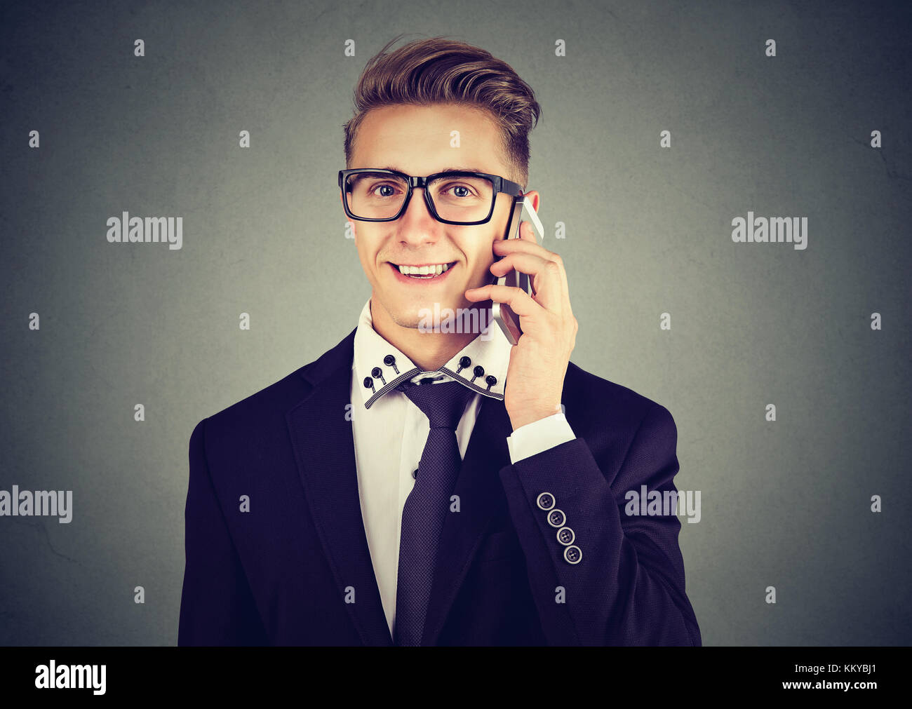 Handsome modern businessman calling on mobile phone Stock Photo - Alamy