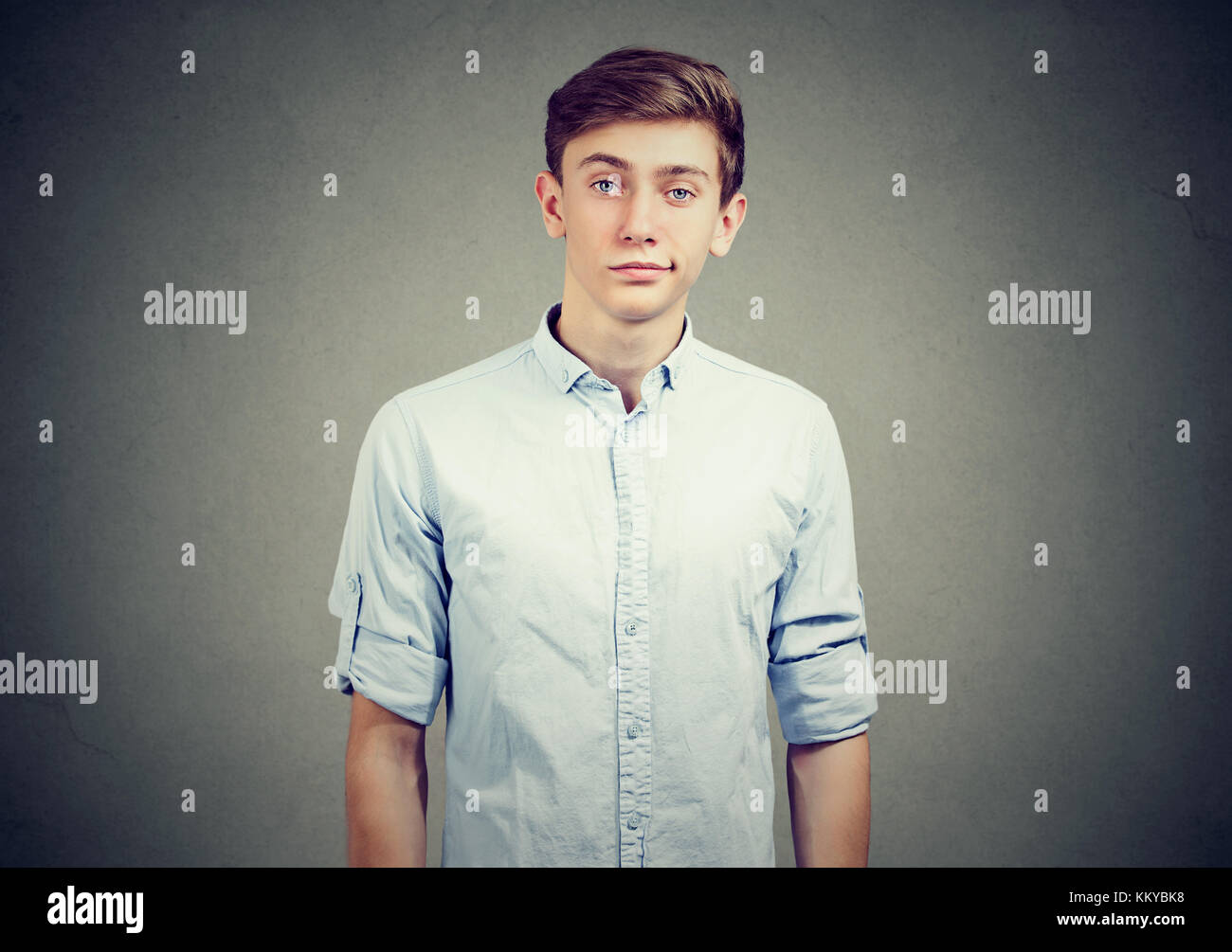 Portrait of skeptical young man looking suspicious, with some disgust ...