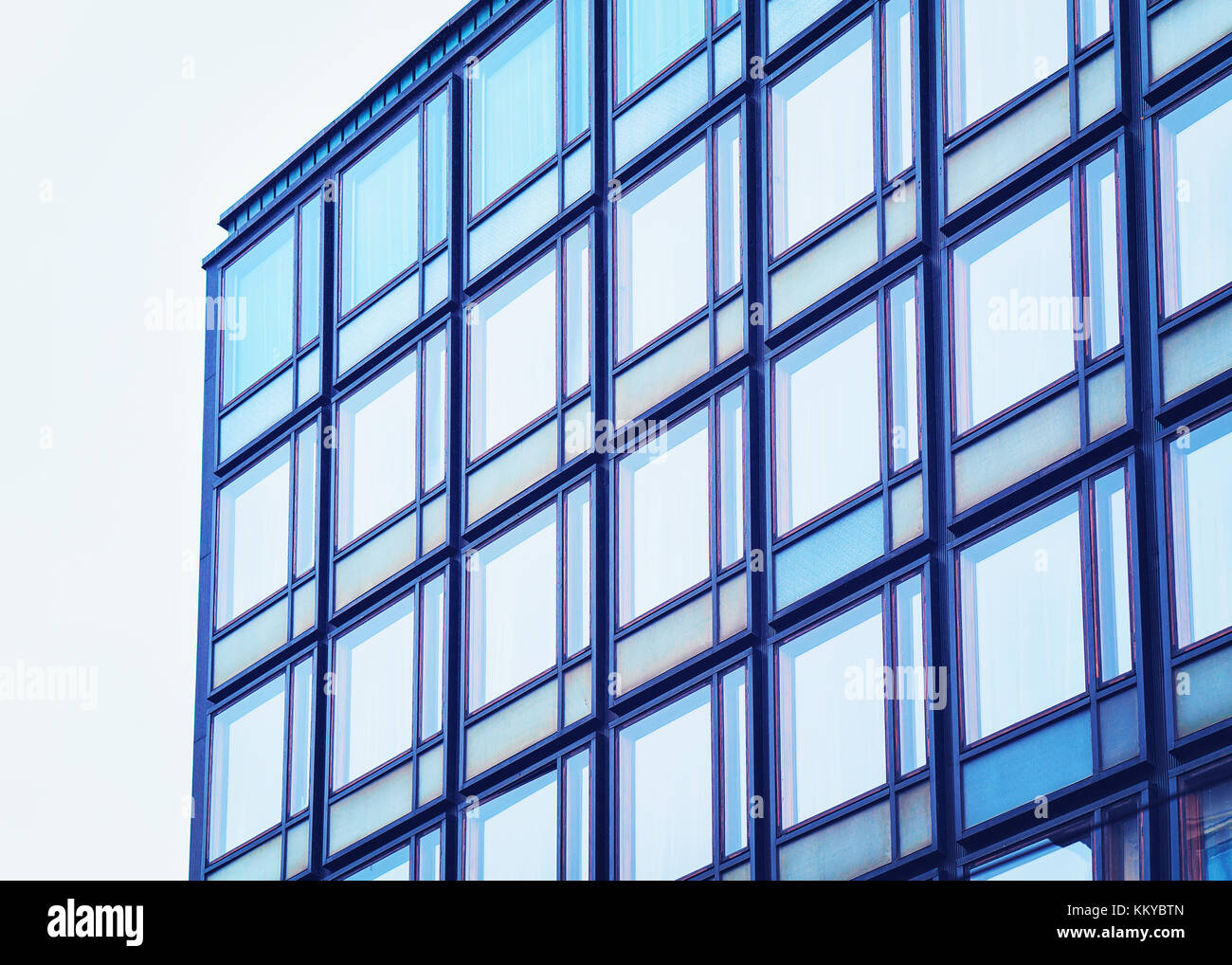 Windows in modern futuristic glass skyscraper reflecting the blue sky ...